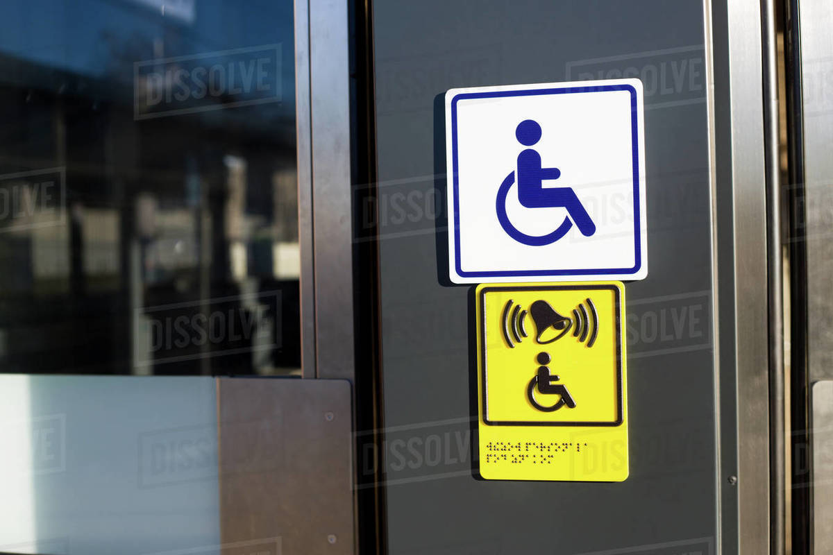 Sign with wheelchair and braille text for people with disabilities next ...
