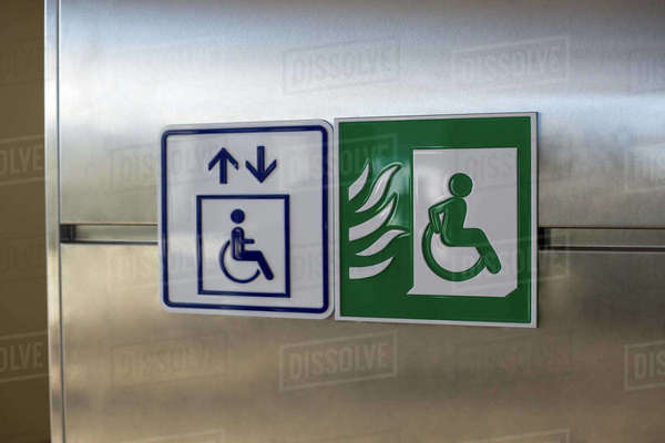 Green wheelchair sign with a person driving away from a fire. Symbol of ...
