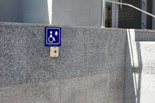 Access to building door for disabled people. Sign with braille text and ...