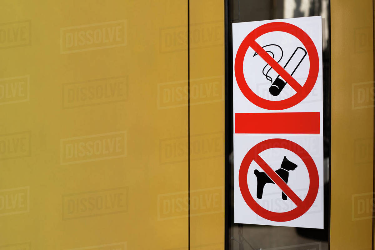 Signs prohibiting smoking and entry into building with dogs. Restricted ...