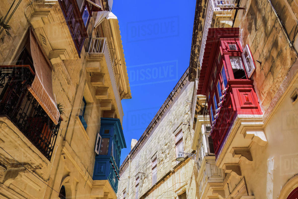 Traditional Maltese limestone buildings with coloured balconies in the ...