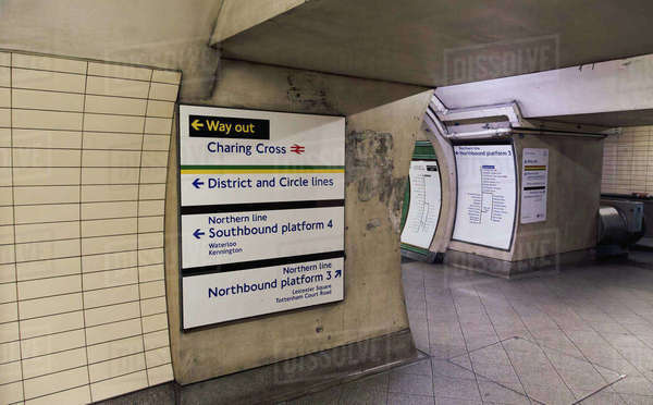 London, UK Tube station with directional signs inside platform ...