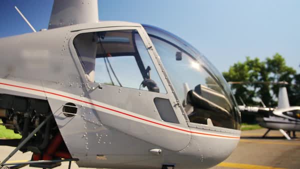 Helicopter stands on the pad.Camera flying orbital of Chopper airplane ...