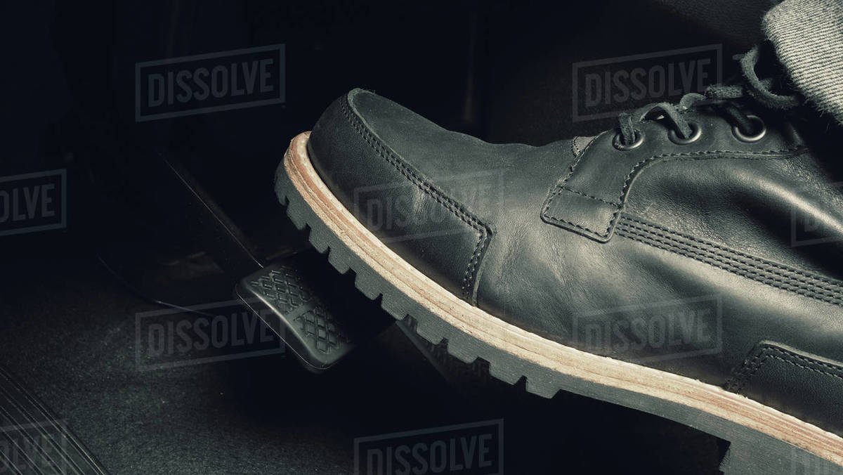Car accelerate and brake foot pedal. Close up foot press or push foot ...