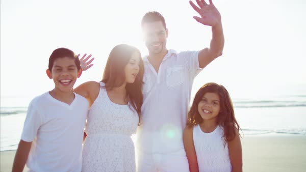 Portrait of family waving hands on their beach holiday - 4K Royalty ...