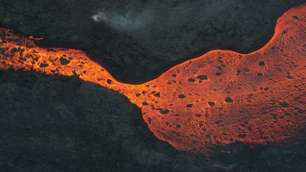 Aerial view of lava river of golden volcanic liquid from active volcano ...