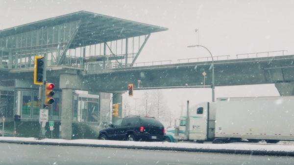 Cars pass as trucks turn off highway in snow storm - HD Royalty-free ...