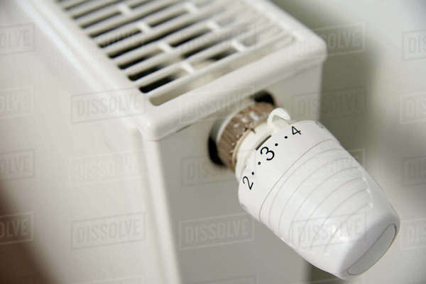 Adjusting temperature on heating radiator thermostat, Turning heat ...