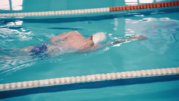 Male athlete swimmer swims in the pool. Professional freestyle swimming ...