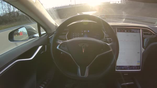 TESLA AUTONOMOUS CAR, MARCH 2018: LENS FLARE: Golden sun rays shine ...