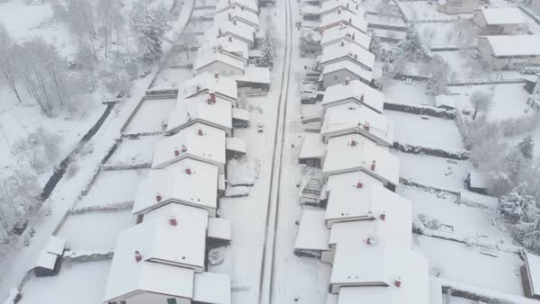Quiet suburban town in white winter. Flying above peaceful suburbs ...