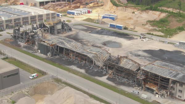 AERIAL: Flying around the black remnants of a factory that burned down ...
