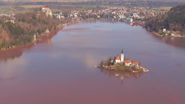 AERIAL, COPY SPACE: Cinematic drone shot of red hued water surrounding ...