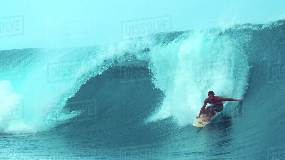 CLOSE UP: Cool surfer drags his hand through the refreshing ocean while ...