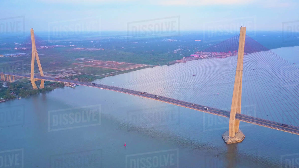 AERIAL: Numerous cars and motorbikes cross the modern concrete bridge ...