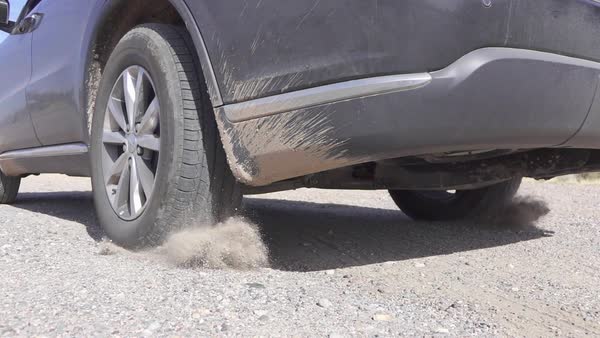 Slow motion close-up: suv car starts and quickly drives away from a ...