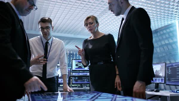 Team of government agents tracking fugitive with help of touchscreen ...