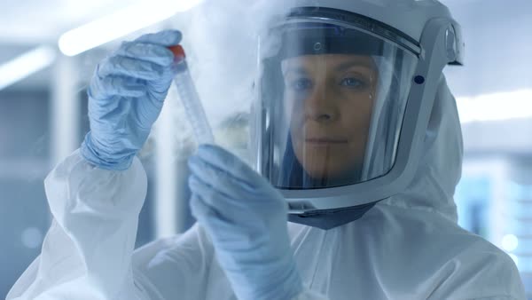 Medical virology research scientist in a hazmat suit with mask, she ...