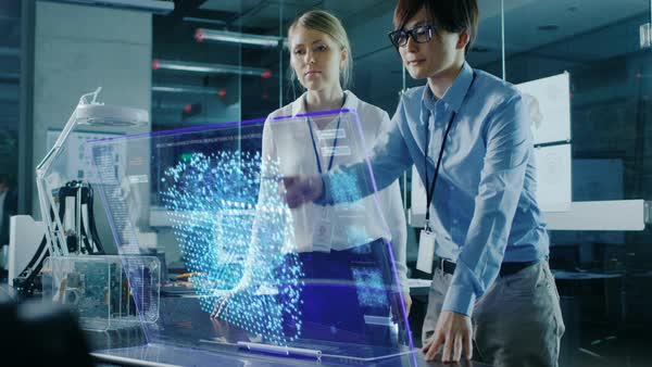 Male and female engineers have discussion while using modern computer ...