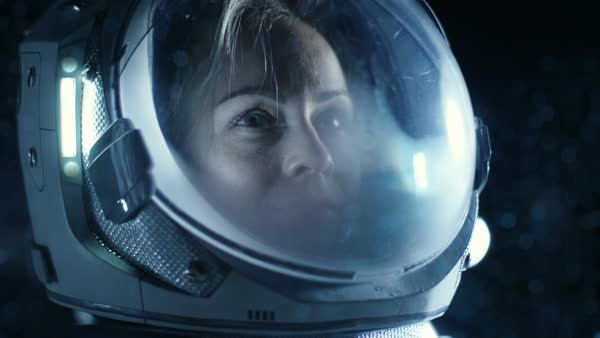 Portrait shot of the courageous female astronaut wearing helmet in ...