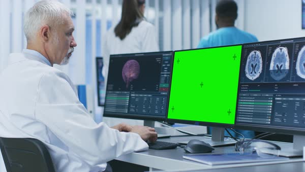 Scientist working with mock-up green screen and ct brain scan images on ...