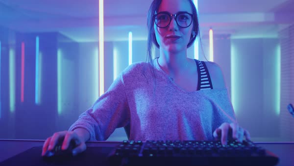 Beautiful professional gamer girl sitting down to play and stream ...