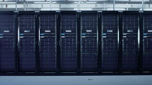 Camera slide-trough shot of a working data center with rows of rack ...