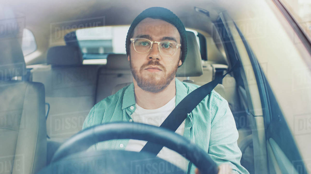 Portrait of Stylish Young Man Drives Car through big Sunny City. Shot ...
