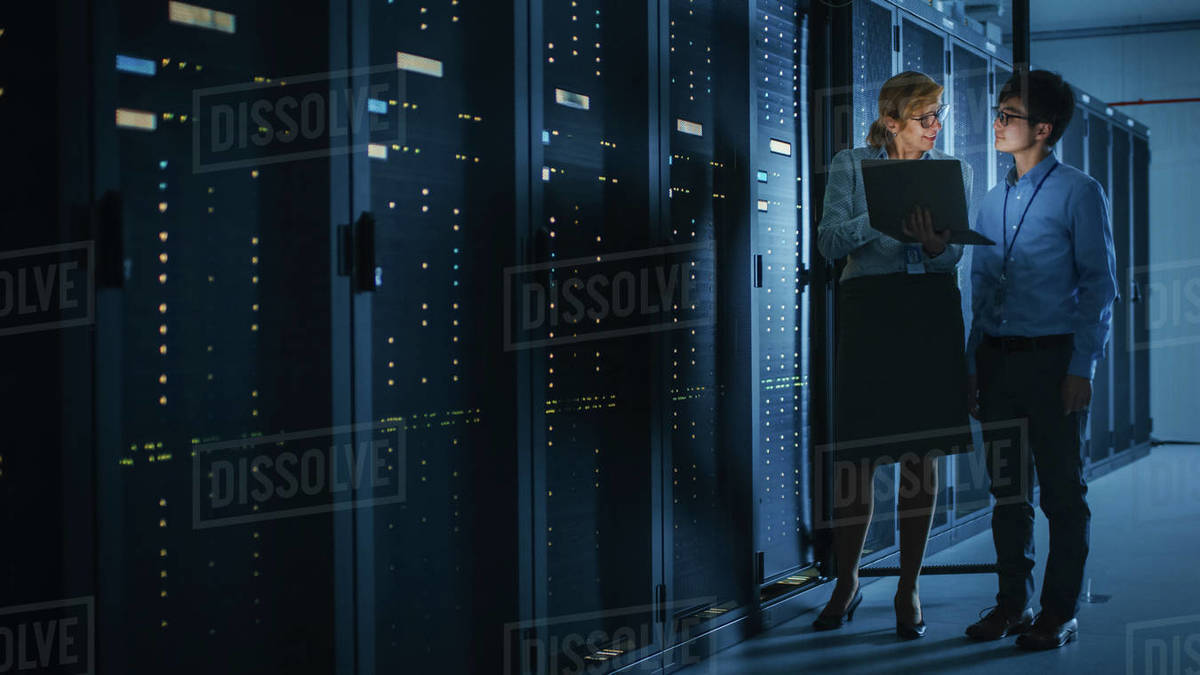 In the Modern Data Center: Engineer and IT Specialist Work with Server ...
