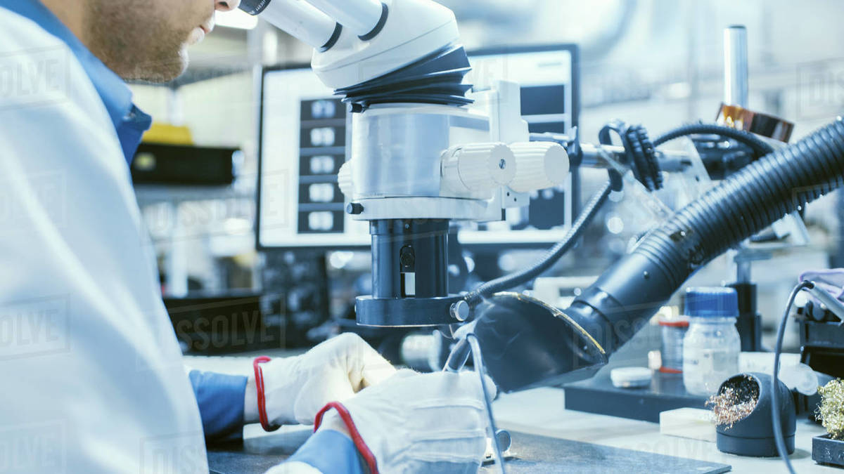 Close-Up Shot of an Electronics Factory Worker in White Work Coat ...