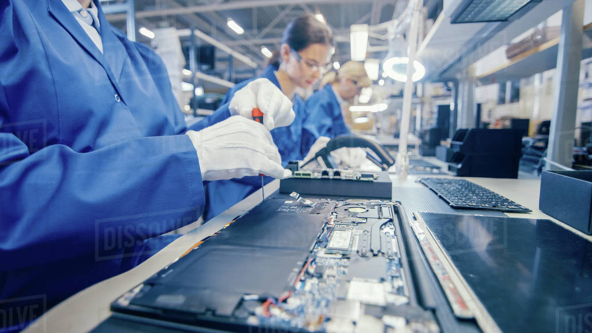 Close-Up of a Female Electronics Factory Worker in Blue Work Coat ...