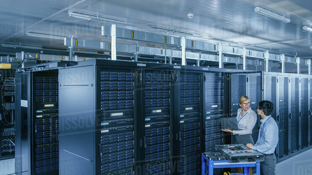 In the Modern Data Center: Engineer and IT Specialist Work with Server ...