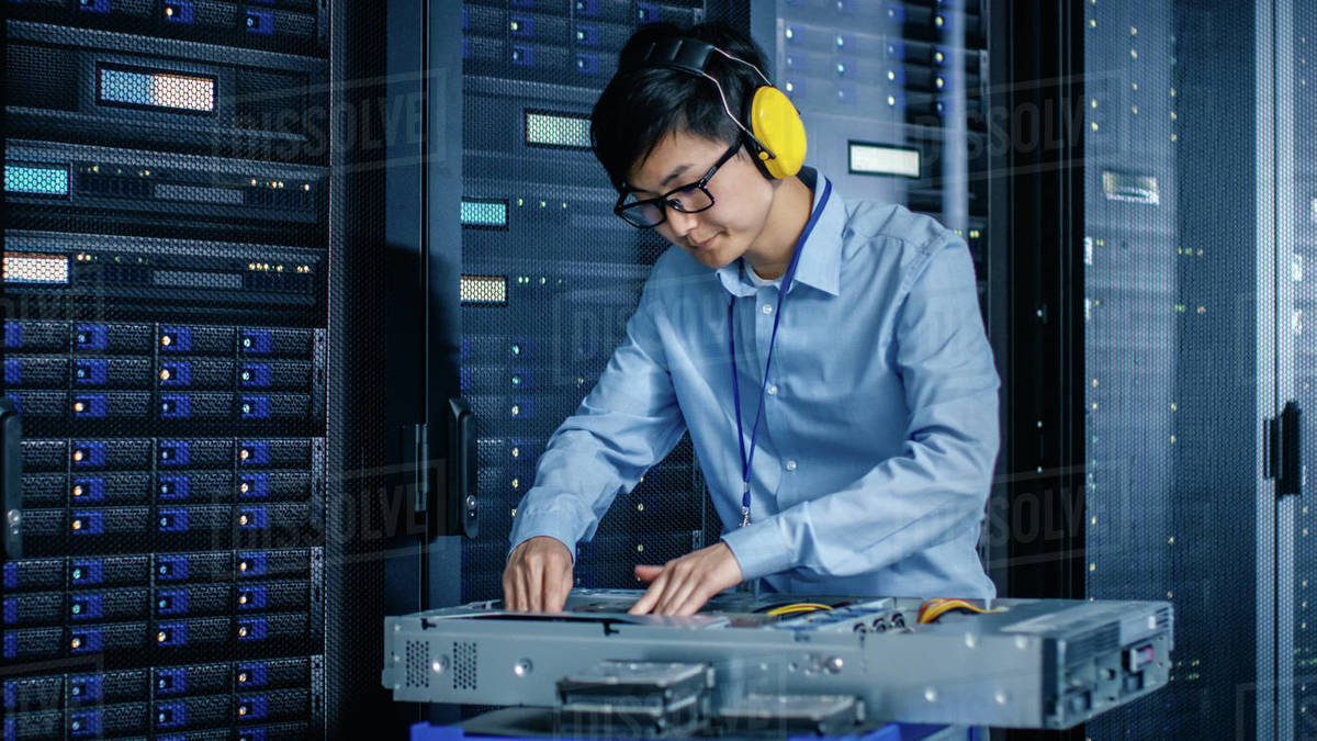 In the Modern Data Center: IT Engineer Wearing Protective Muffs ...