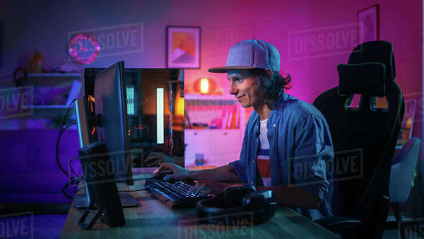 Professional gamer playing first-person shooter online video game on ...