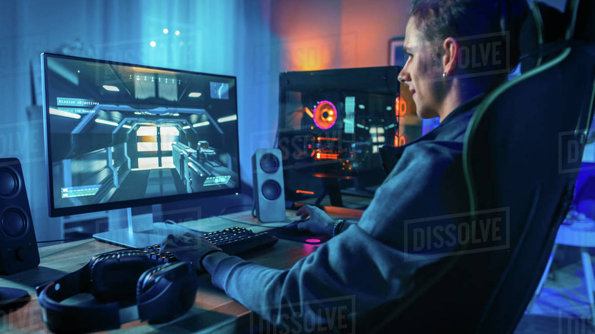Happy gamer playing first-person shooter online video game on his ...