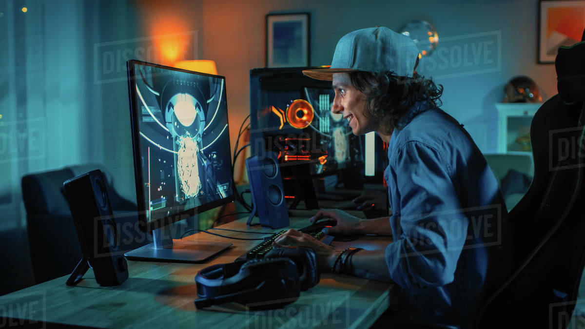 Professional gamer playing first-person shooter online video game on ...