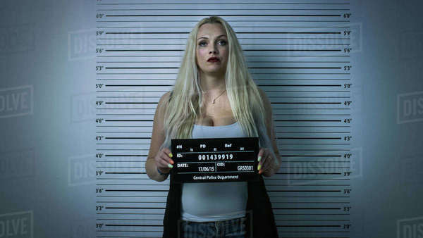 In Police Station Arrested Woman Posing for Front-View Mugshot. Wears ...