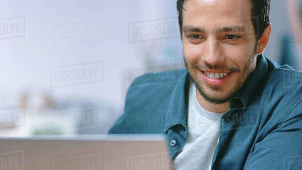 Portrait of a Handsome Young Man Using His Laptop Computer. His Sitting ...