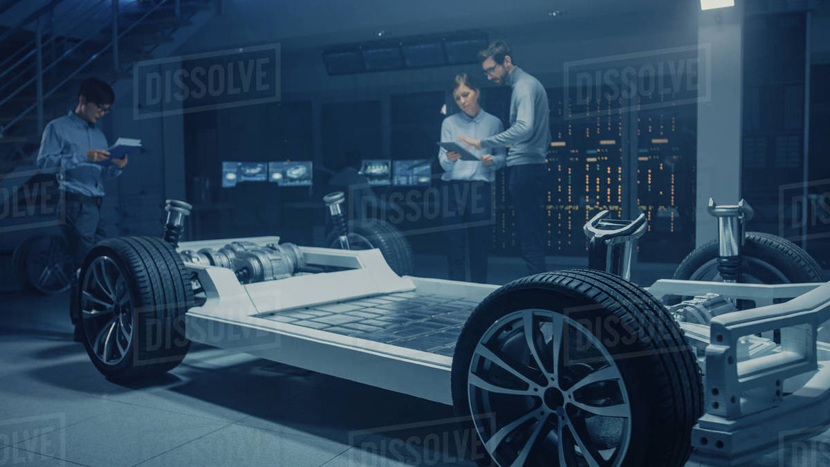 Diverse Automobile Engineers Talking while Working on Electric Car ...