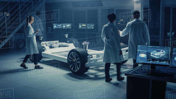 Team of Automotive Engineers and Scientists Discussing, Designing and ...