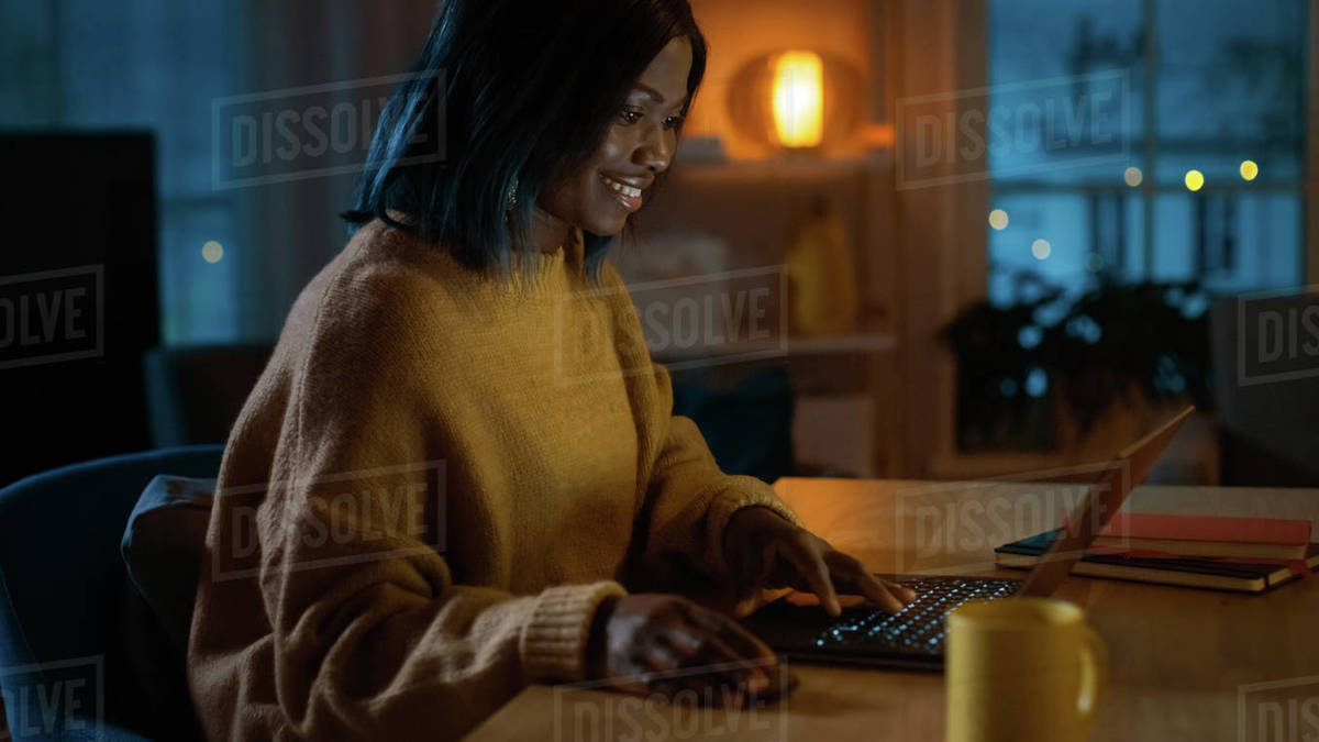 Portrait of Beautiful Black Girl Uses Computer while Sitting at Her ...