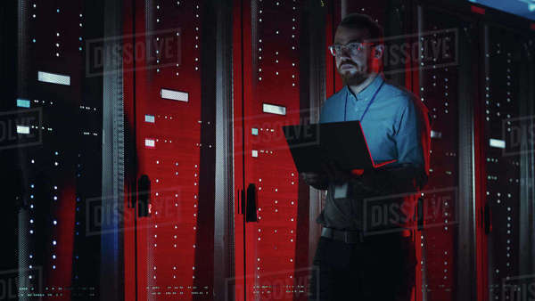 Angry Bearded IT Specialist in Glasses is Walking Through Server Rack ...