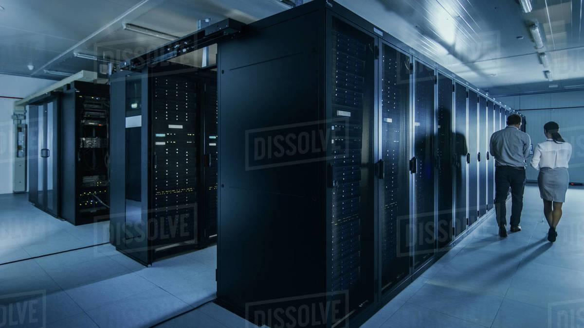 Shot of an IT Admin with a Laptop Computer and Young Technician ...