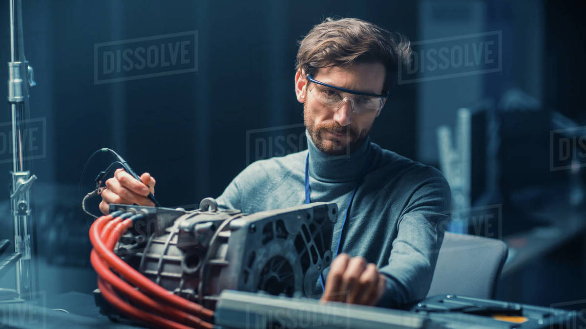 Professional Automotive Engineer in Glasses with a Computer and ...