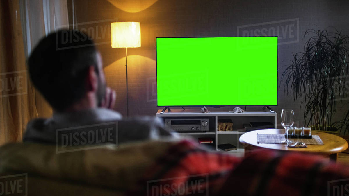 In the Evening Back View of a Middle Aged Man Sitting on a Couch ...