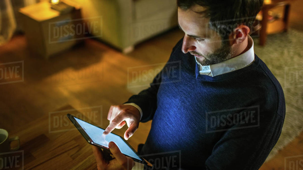 Respectable Middle Aged Man Sitting at His Desk Using Tablet Computer ...
