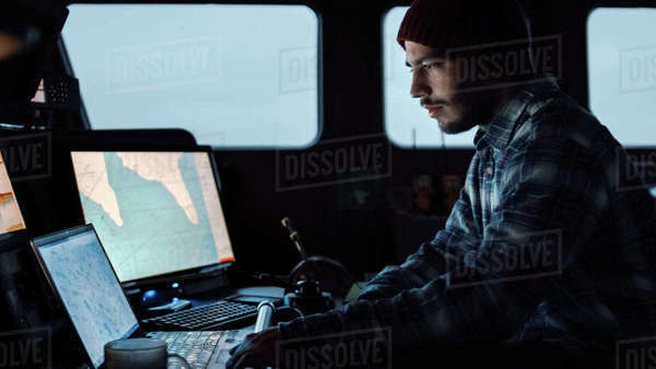 Shot of a Serious Captain on a Commercial Fishing Ship Surrounded by ...