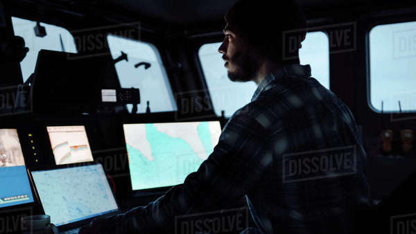 Shot of a Serious Captain on a Commercial Fishing Ship Surrounded by ...