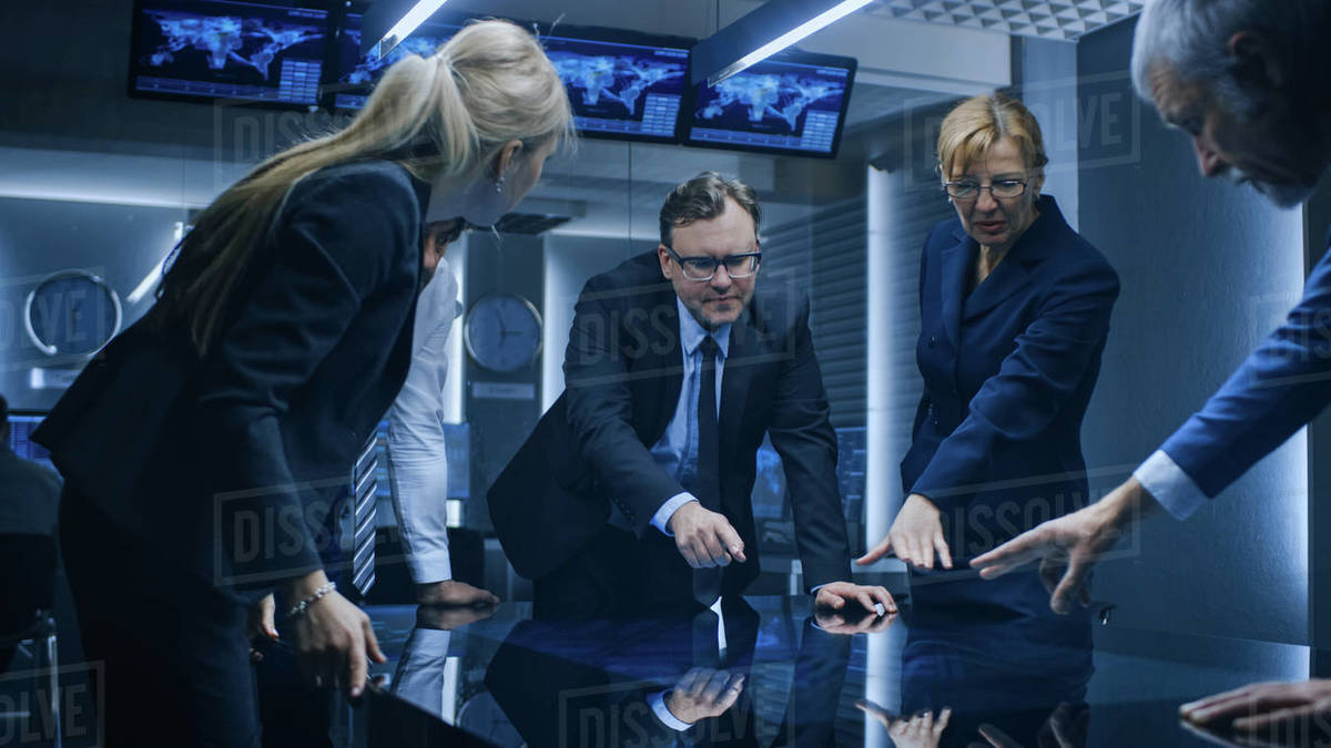 Diverse Team of Government Intelligence Agents Standing Around Digital ...