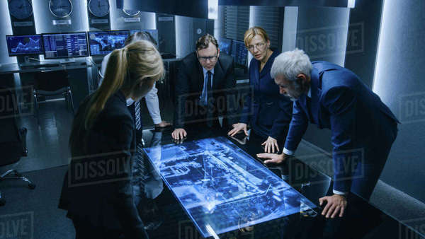 Team of Government Intelligence / FBI Agents Standing Around Digital ...